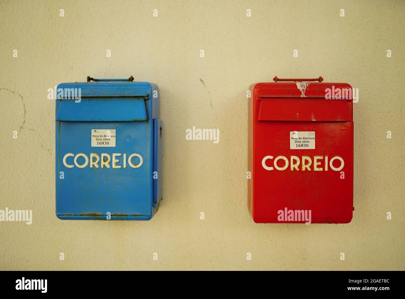 Red and blue mailboxes on the wall Stock Photo - Alamy