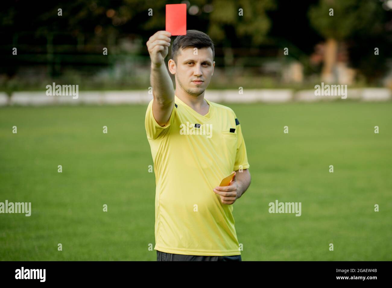 Referee showing a red card to a displeased football or soccer player ...