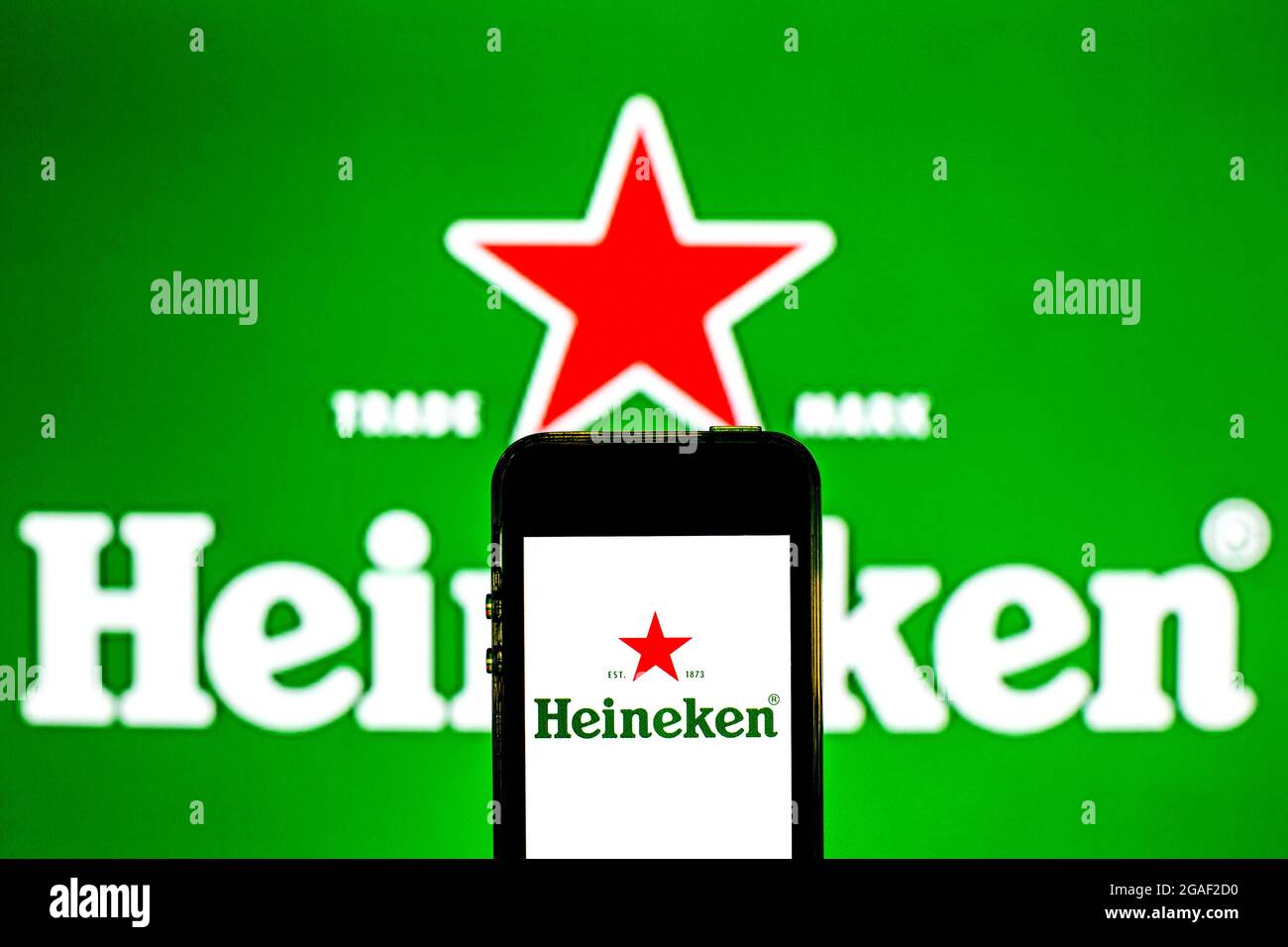 In this photo illustration a Heineken logo seen displayed on a ...