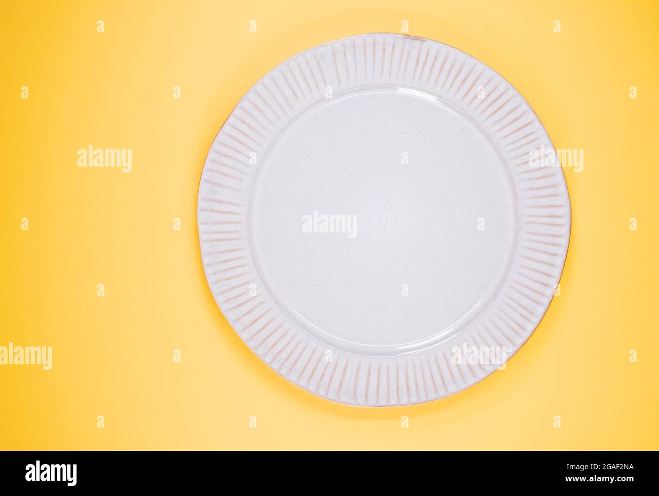 Top view of a paper plate isolated on a yellow background with space ...