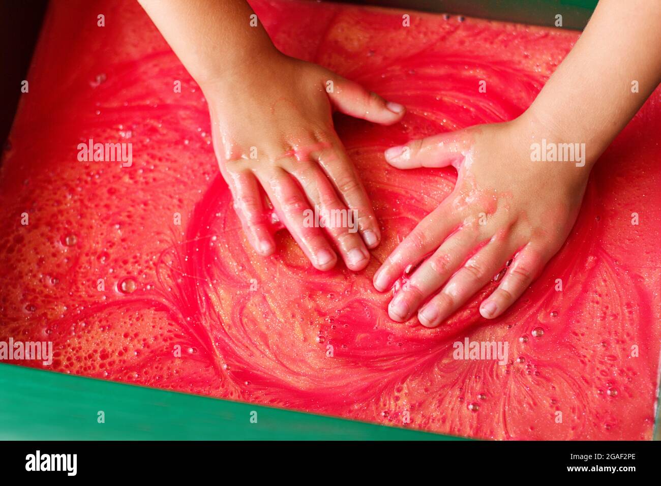 The hands of a child playing with a slime. Children's art project ...