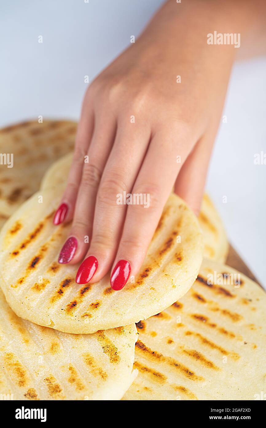 Woman holds Arepa, traditional food of Colombia and Venezuela Stock ...