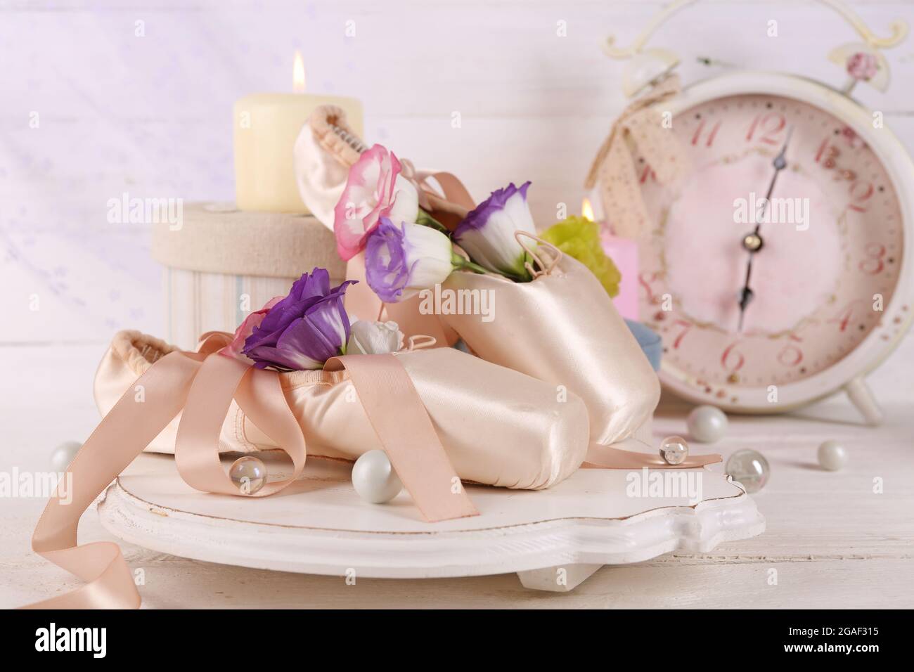 Beautiful composition of decorated ballet shoes with old clocks on ...