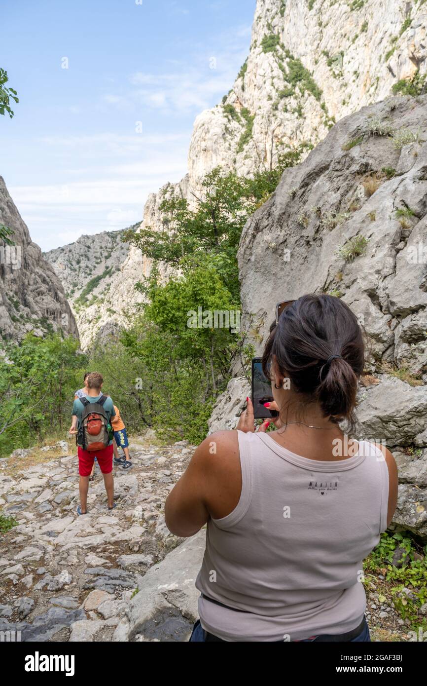 STARI GRAD, CROATIA - Jul 14, 2021: A woman photographing her family on ...