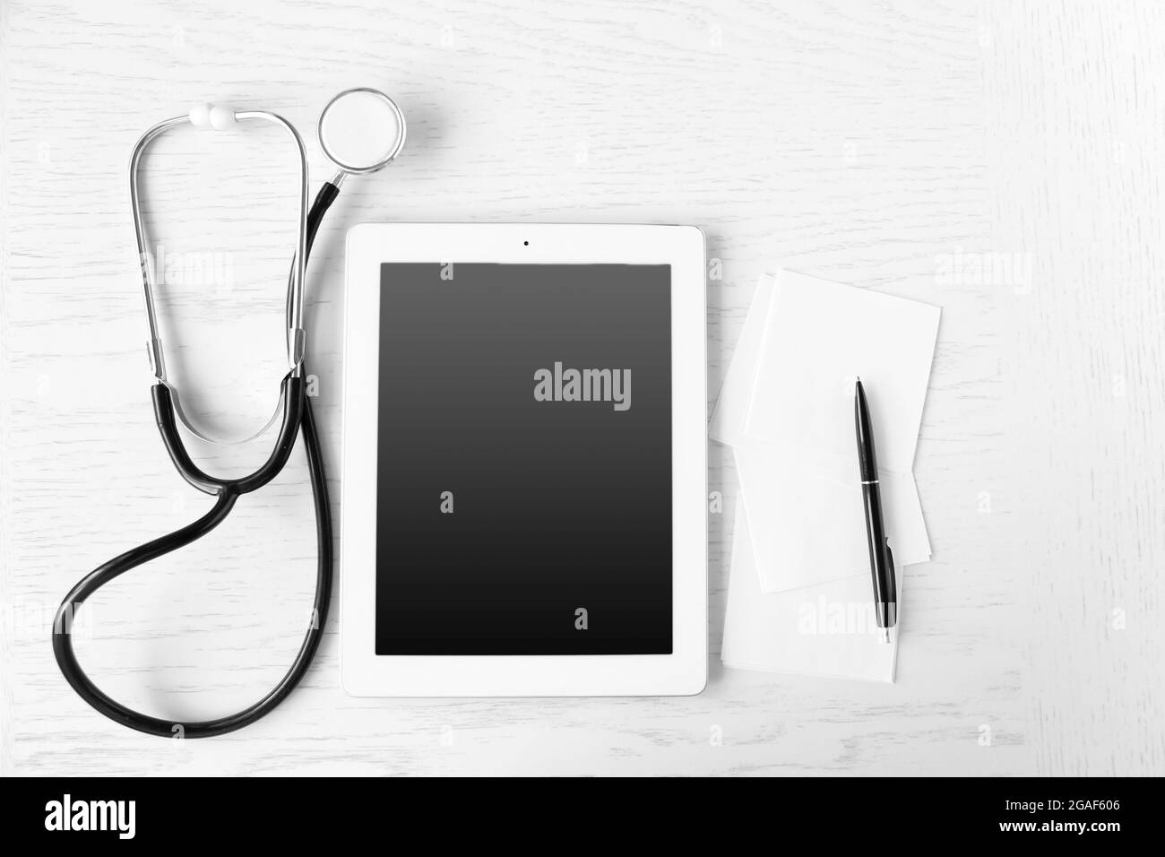 Medical tablet with screen empty screen on wooden table Stock Photo - Alamy