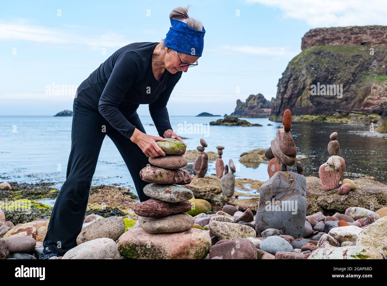 Caroline Walker, stone stacker, balances stones in the European Stone ...
