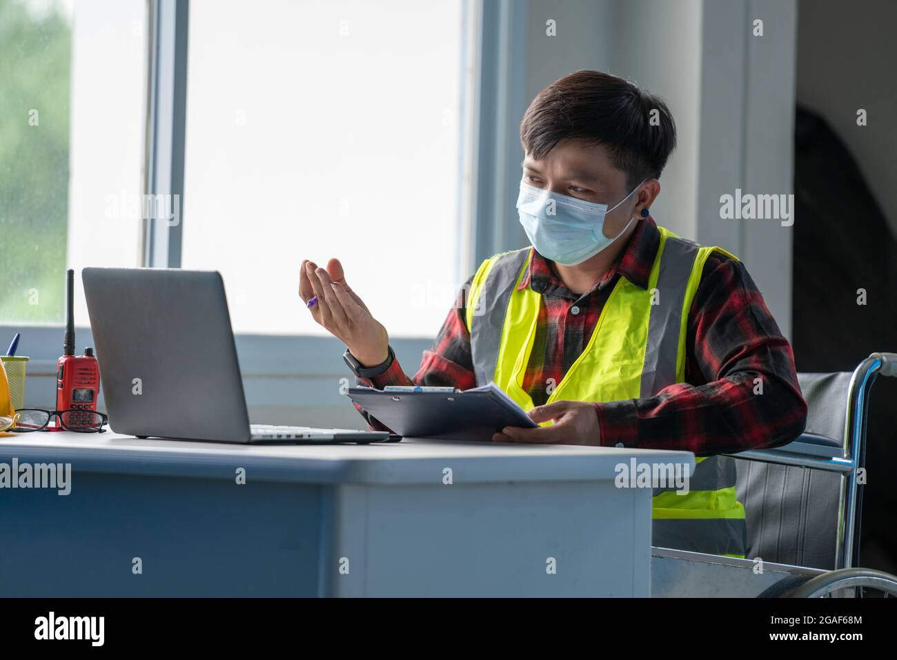 Disabled person engineering video call working in the office Stock ...