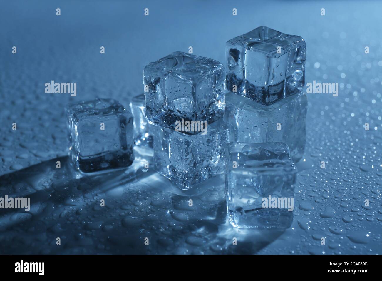 Melting ice cubes under blue light, close up Stock Photo - Alamy