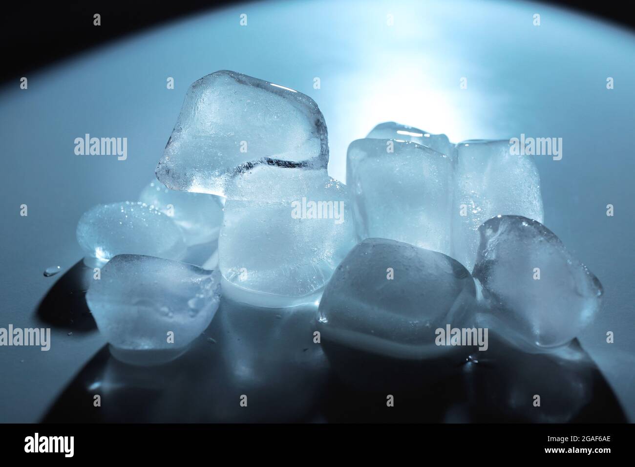 White ice cubes under blue light, close up Stock Photo - Alamy