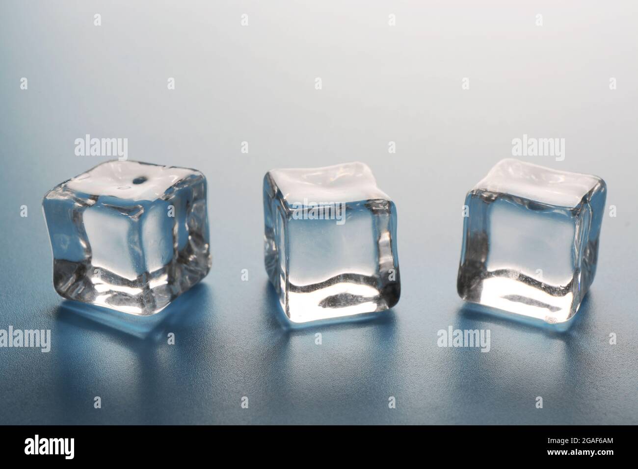 Perfect ice cubes in a row on grey background, close up Stock Photo - Alamy