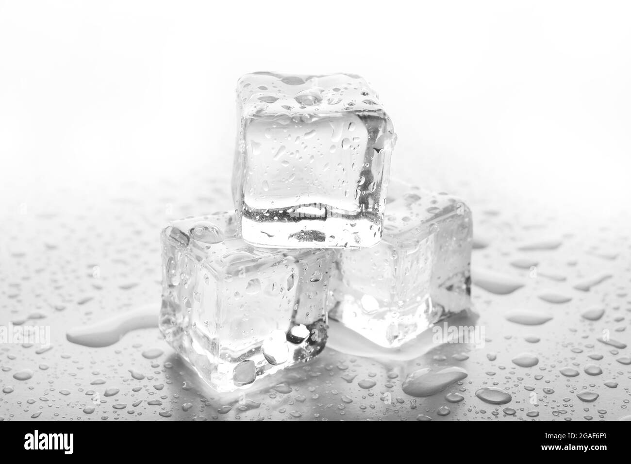 Melting ice cubes on grey background Stock Photo - Alamy