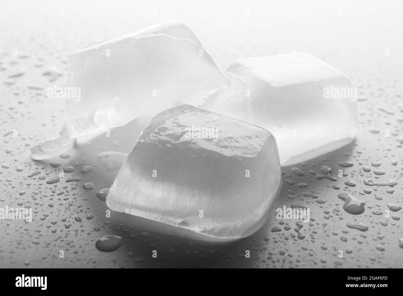 Matted ice cubes with drops around on light-grey background Stock Photo ...