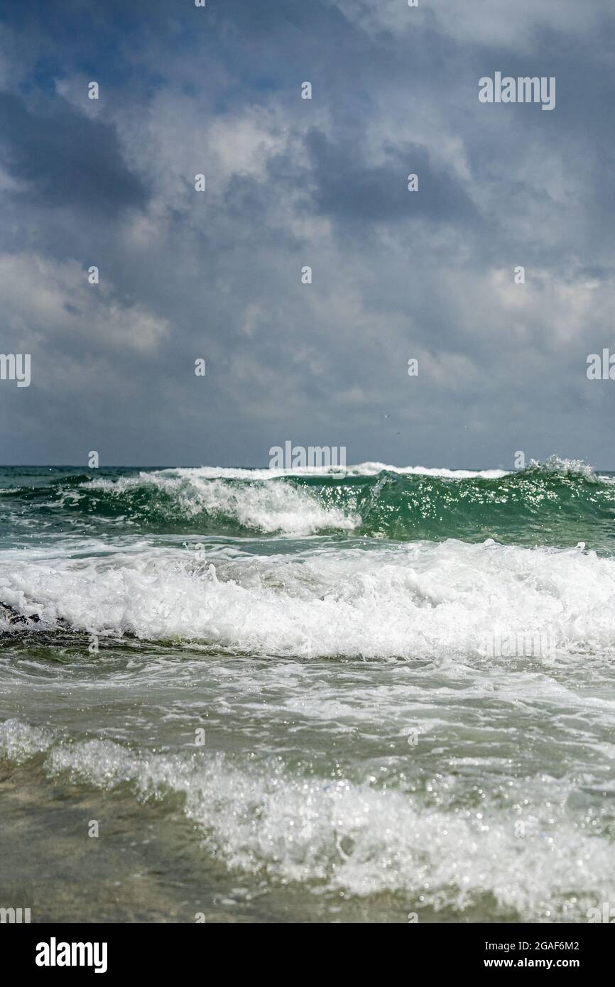 Vertical shot of waves splashing on the seashore Stock Photo - Alamy