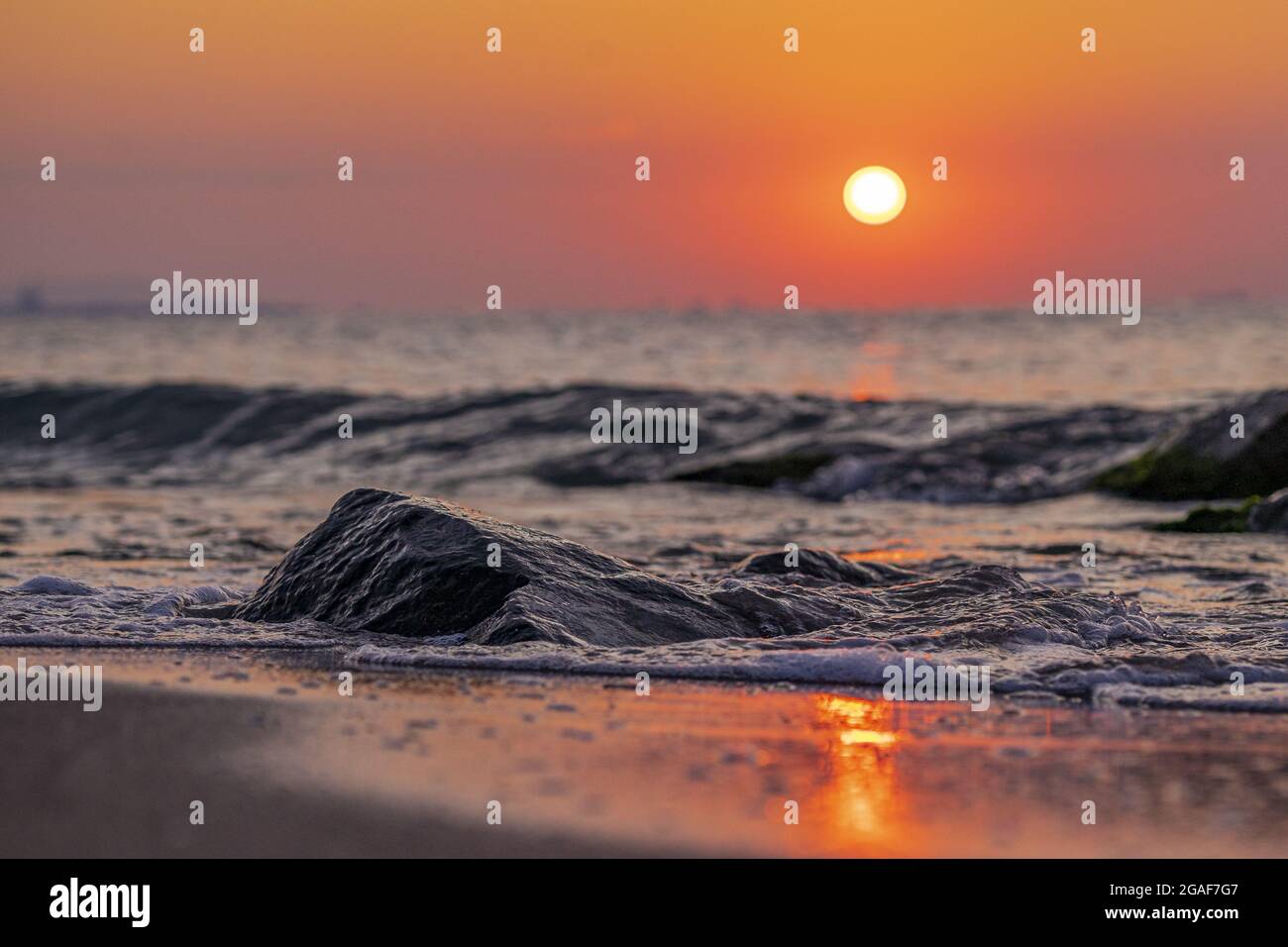Beautiful sunset at sea with raging waves Stock Photo - Alamy