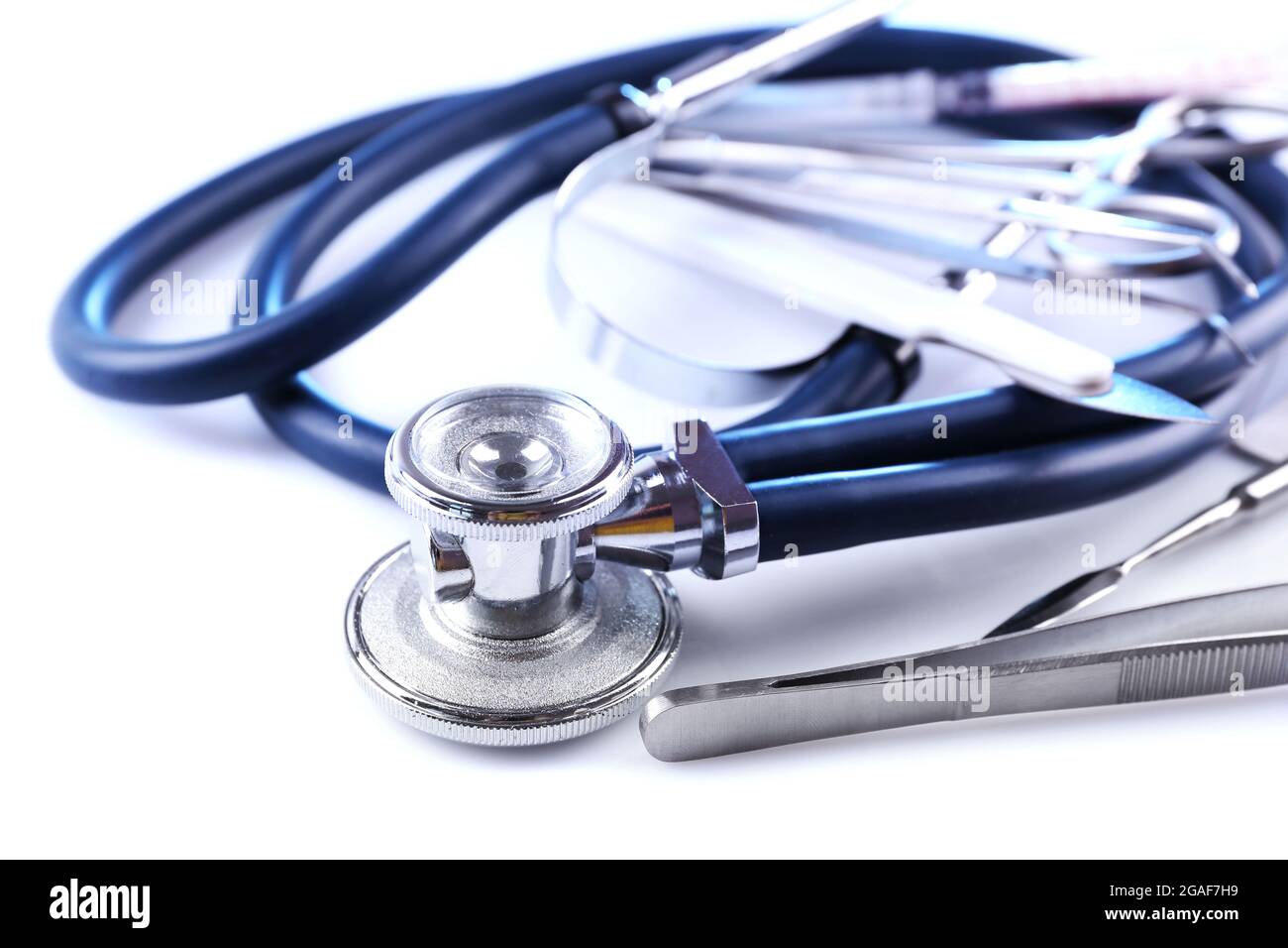 Stethoscope and surgery instruments on white background, close up Stock ...