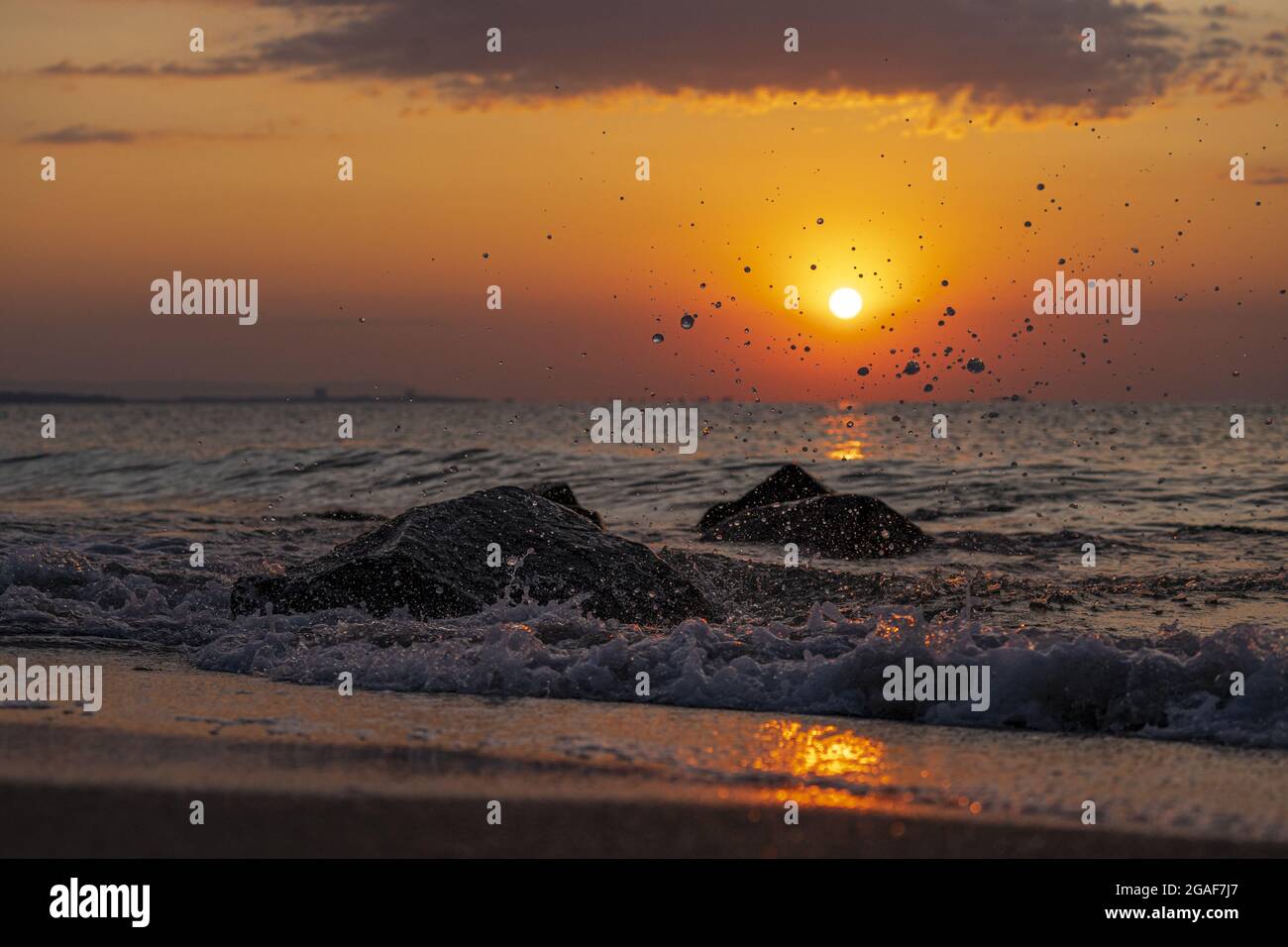 Beautiful sunset at sea with raging waves Stock Photo - Alamy