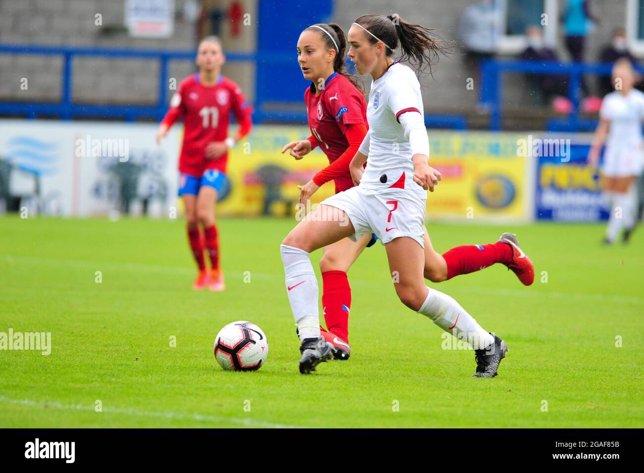 Grace Clinton (7 England) holds off a challenge during the friendly ...