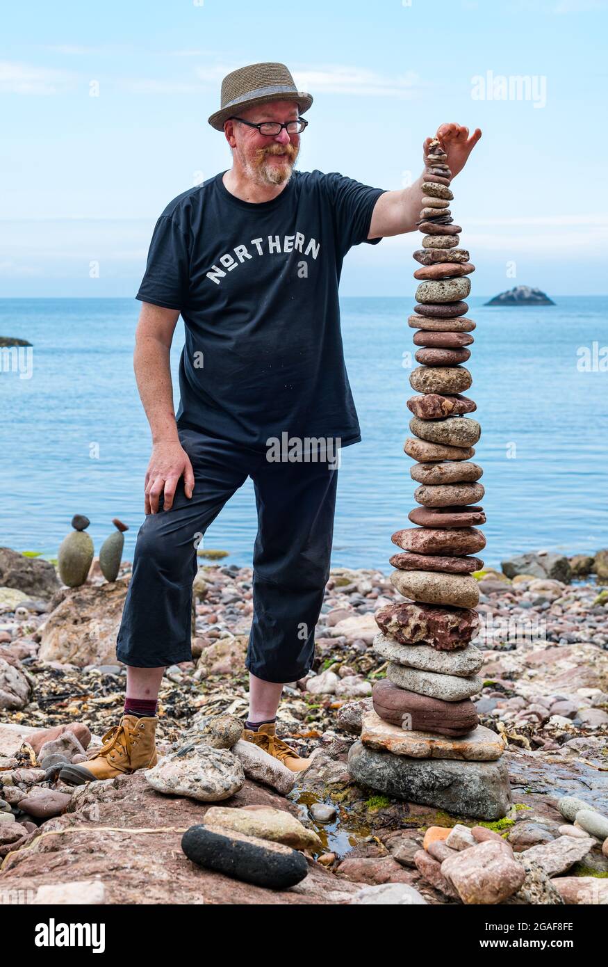 Neil Andrews stacks stones in a tower in the European Stone Stacking ...