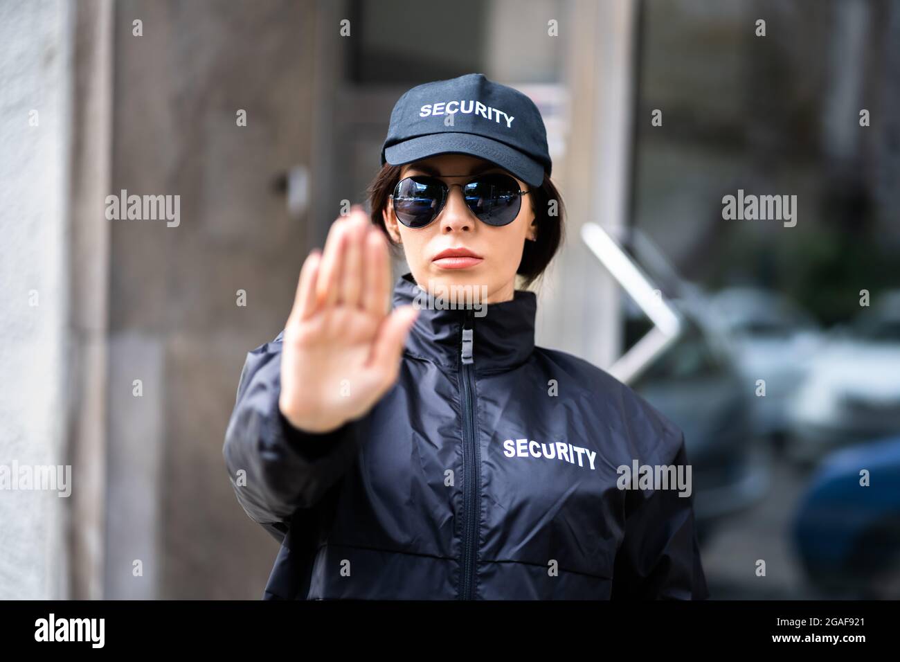 Confident Security Guard Making Stop Gesture Outside Building Stock ...