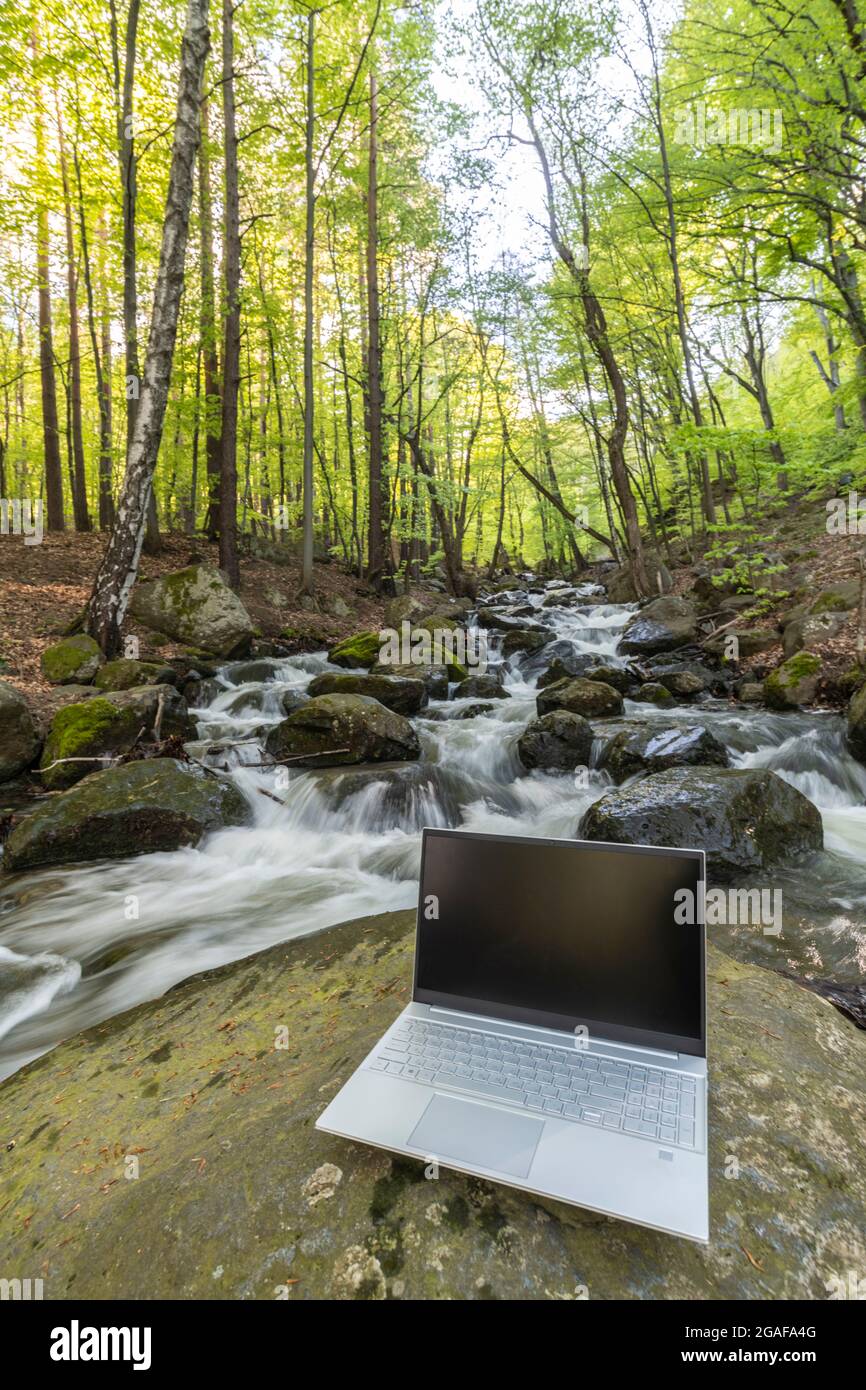 A laptop left on the stones. Technology in nature concept Stock Photo ...