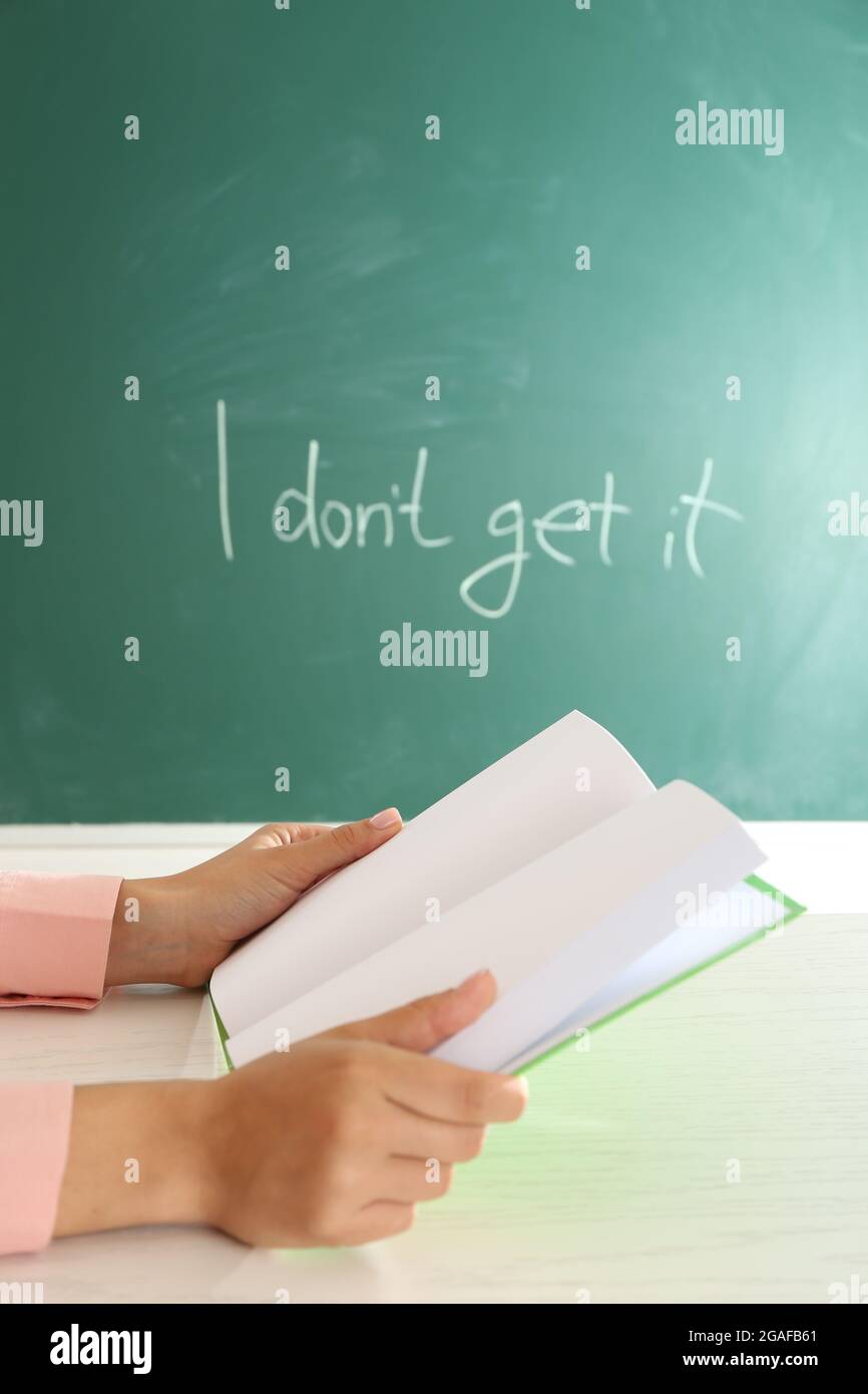 Women hands with book on blackboard background Stock Photo - Alamy