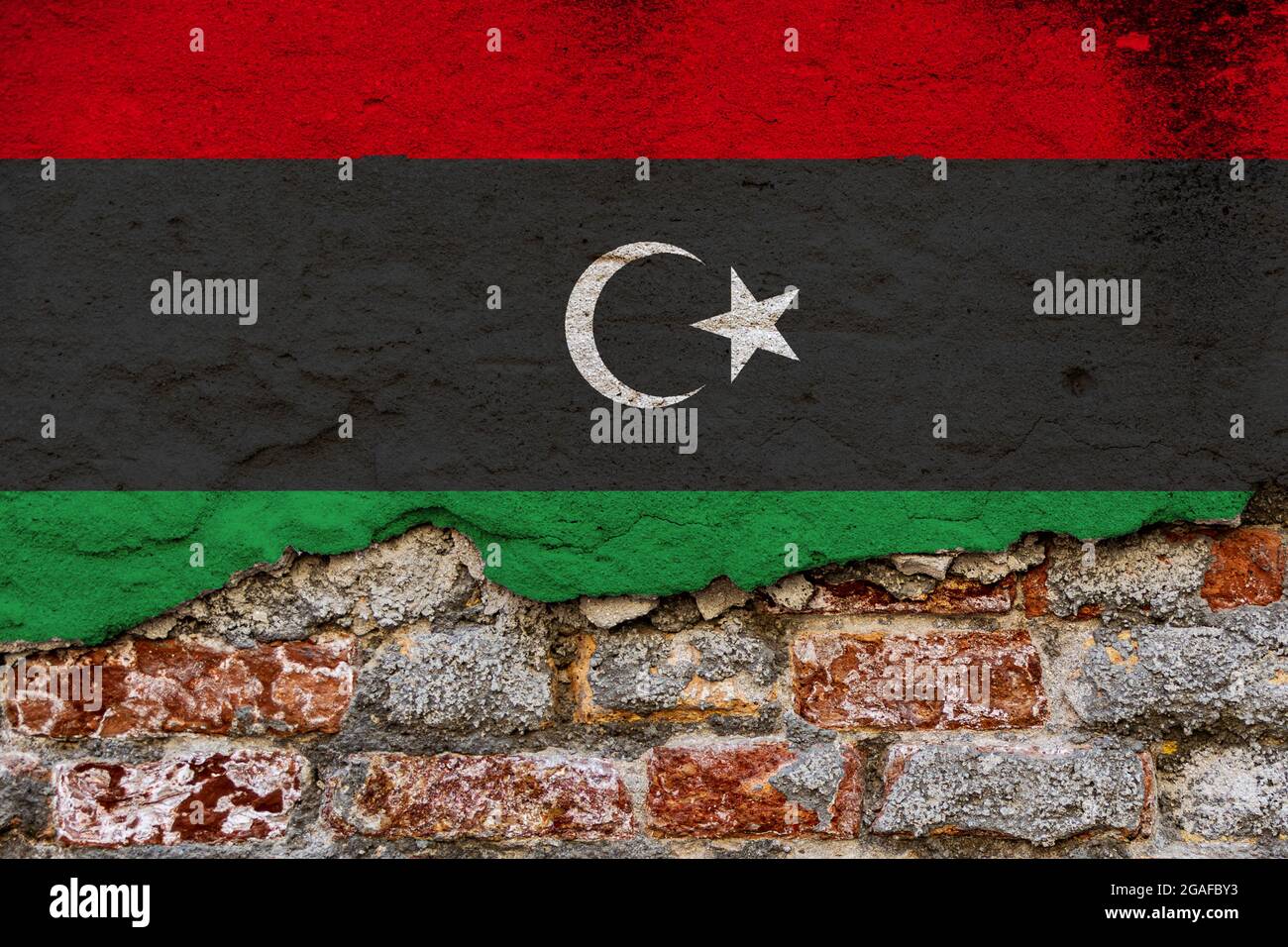 Graphic Concept with a Flag of Libya painted on a damaged brick wall ...