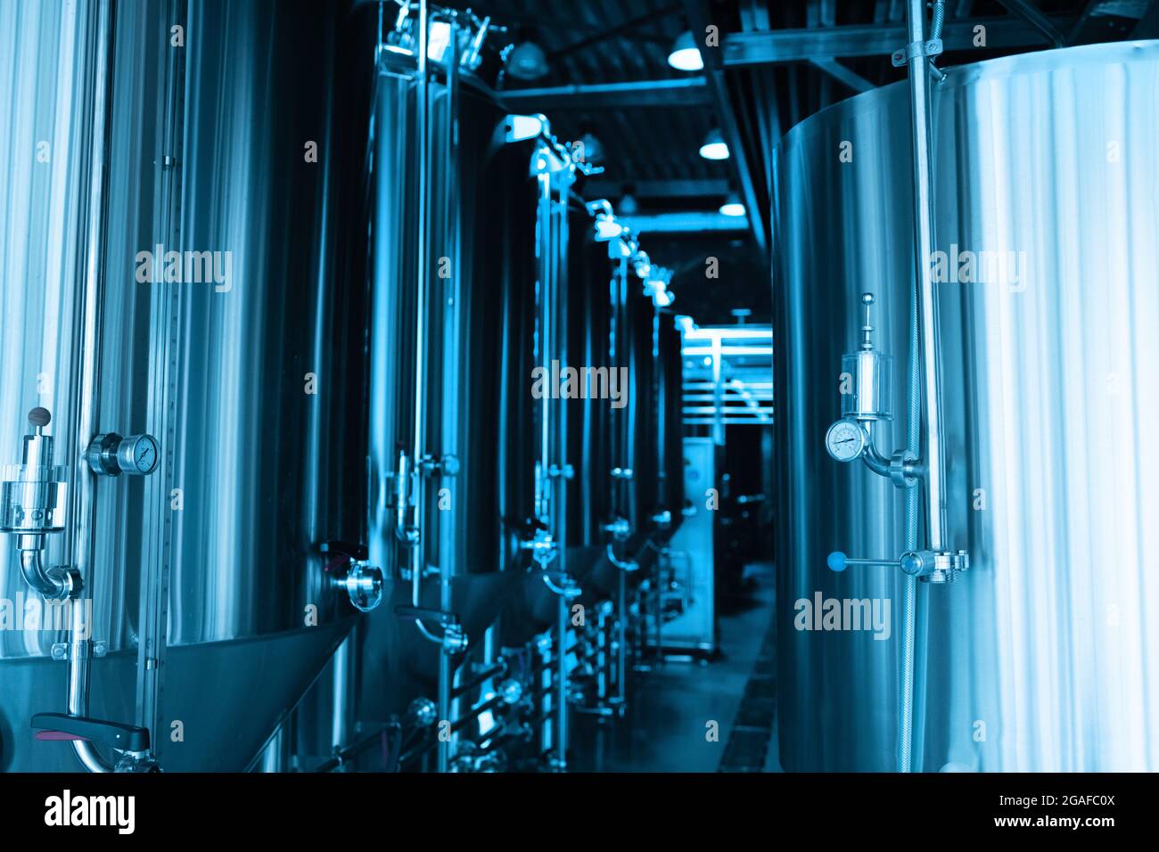 Industrial interior of modern craft brewery with chrome cylindrical ...