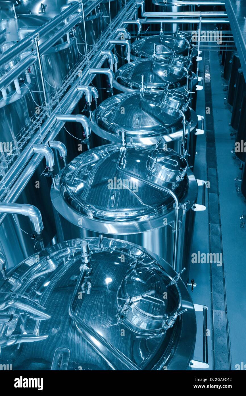 Private microbrewery. Modern beer plant with brewering kettles, tubes ...