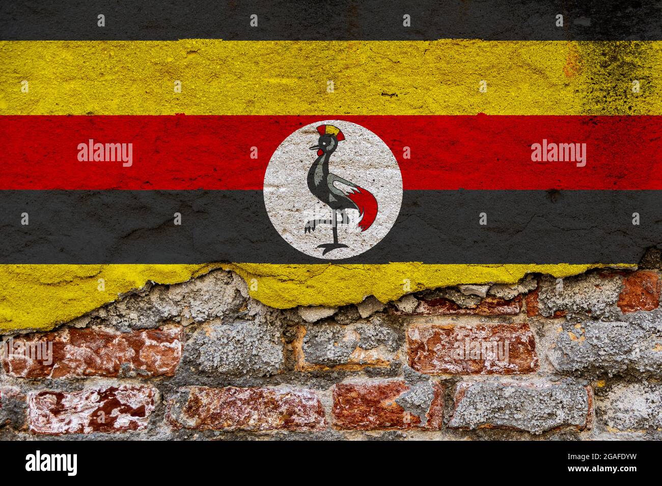 Graphic Concept with a Flag of Uganda painted on a damaged brick wall ...