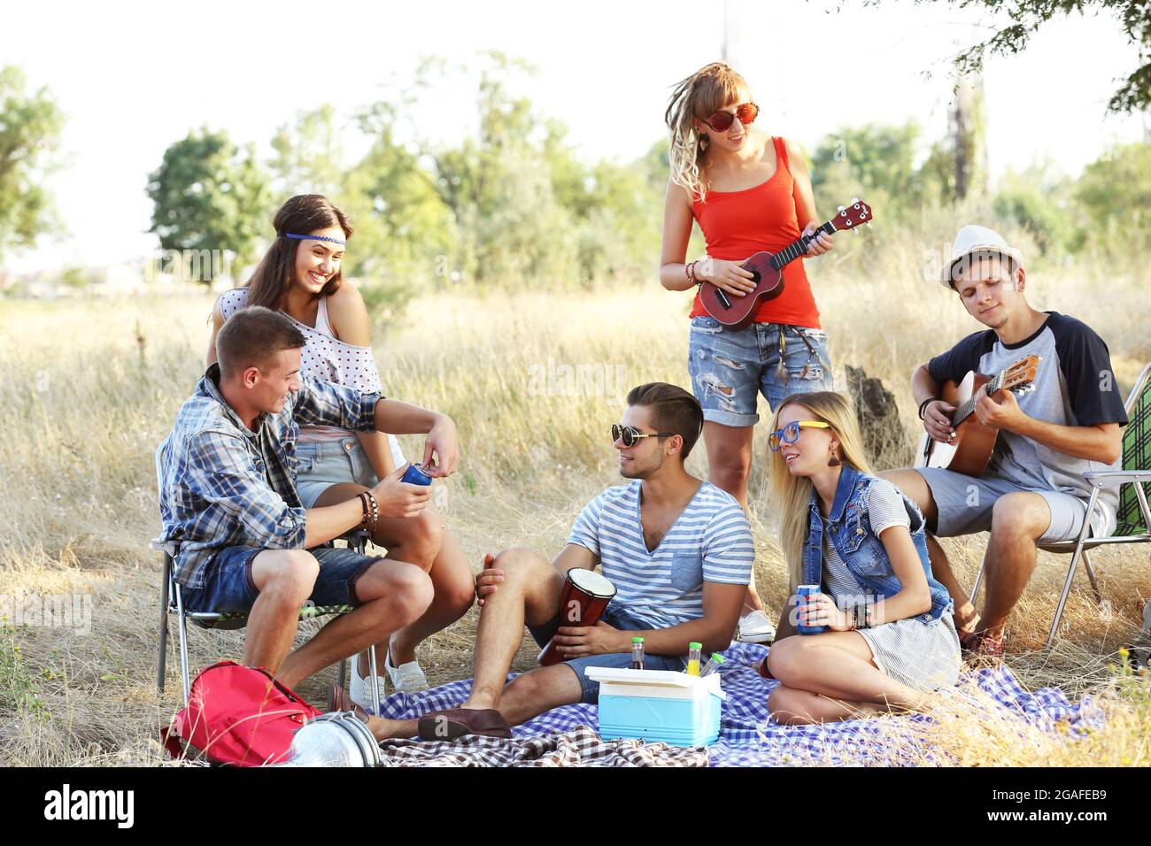 Young hippie people relaxing in the forest outdoors Stock Photo - Alamy