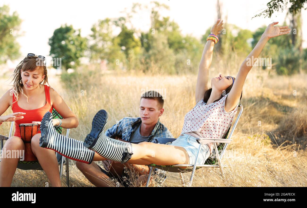 Joyful smiling friends relaxing in the forest outdoors Stock Photo - Alamy