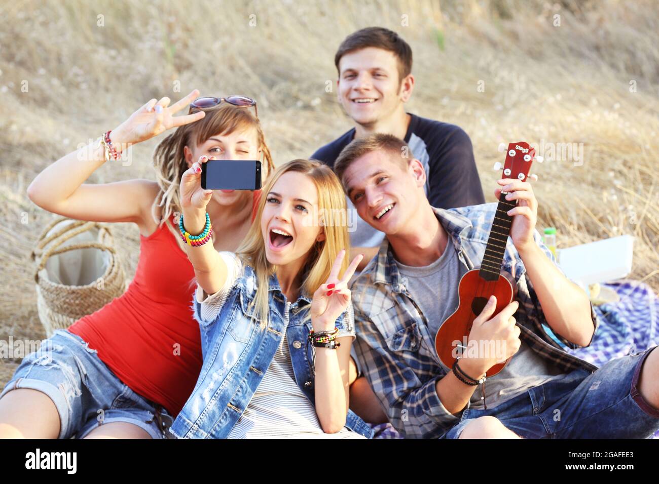 Joyful smiling friends relaxing in the forest outdoors Stock Photo - Alamy