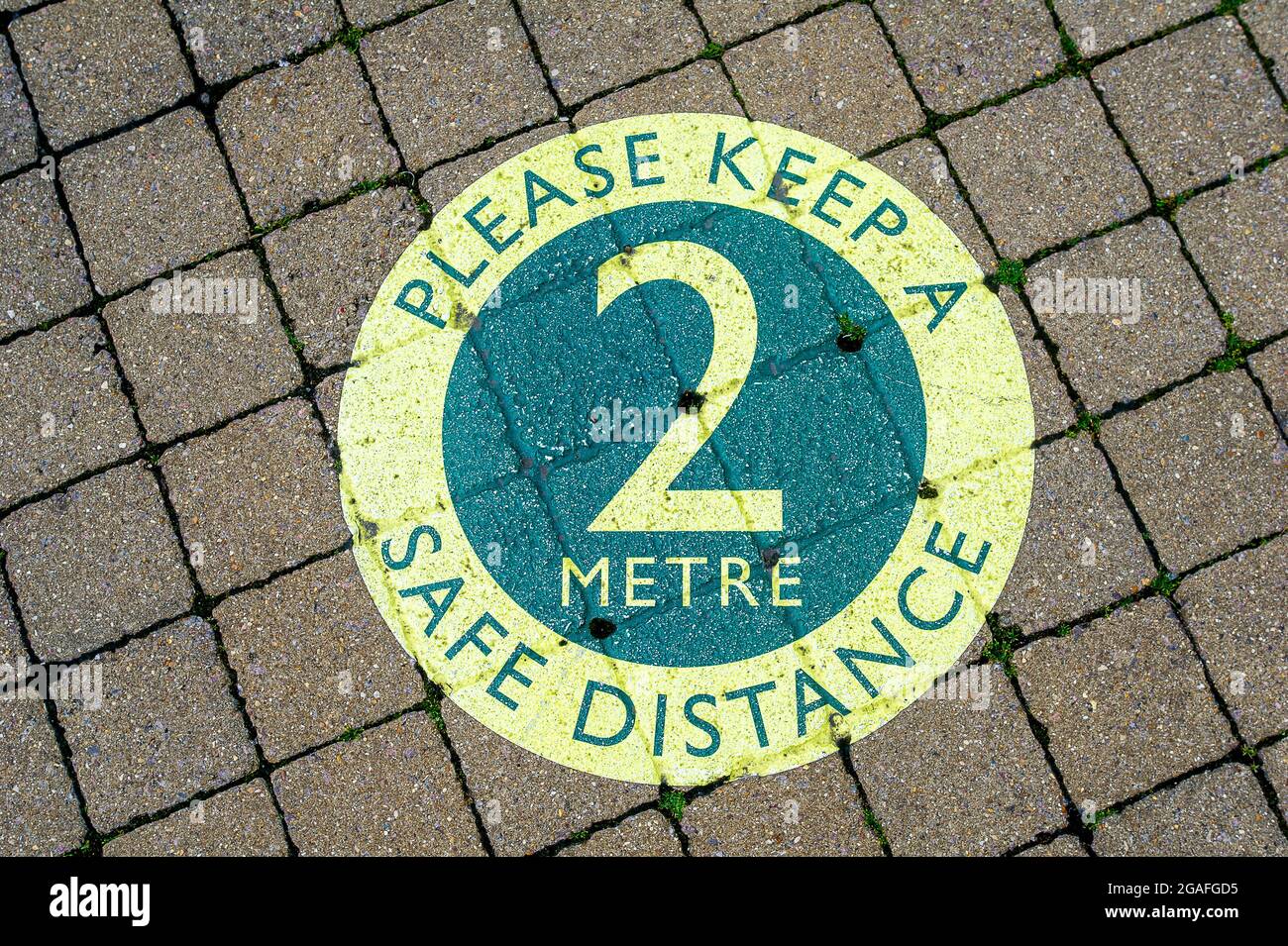 Windsor, Berkshire, UK. 26th July, 2021. A 2 metre safe distance sign ...