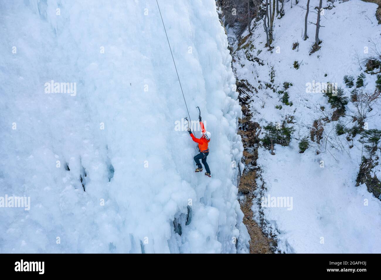 Aerial shot of an ice slope bumps, ridges, and icicles by which ...