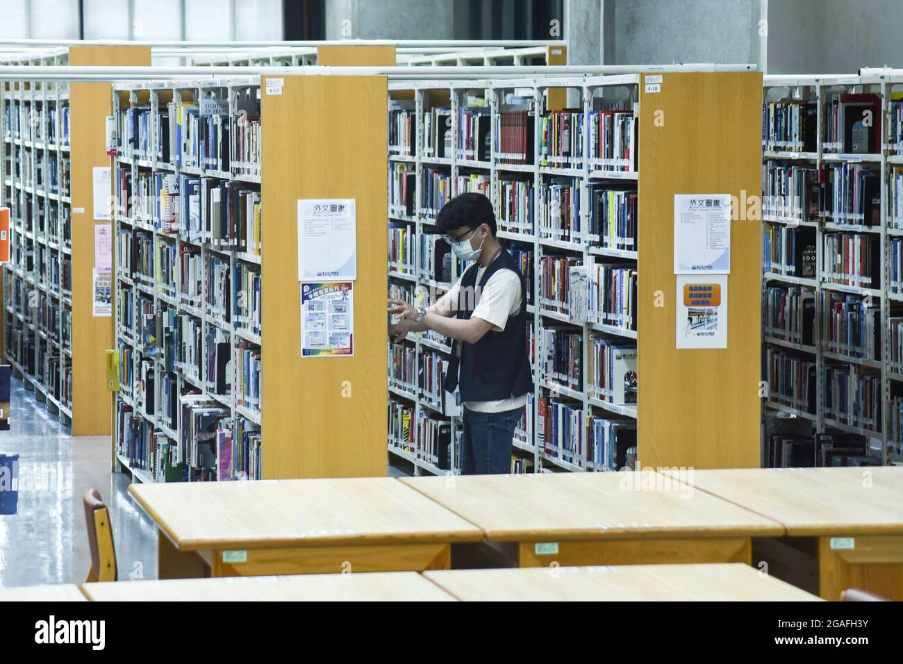Taipei, Taiwan. 29th July, 2021. A librarian seen sorting books on ...