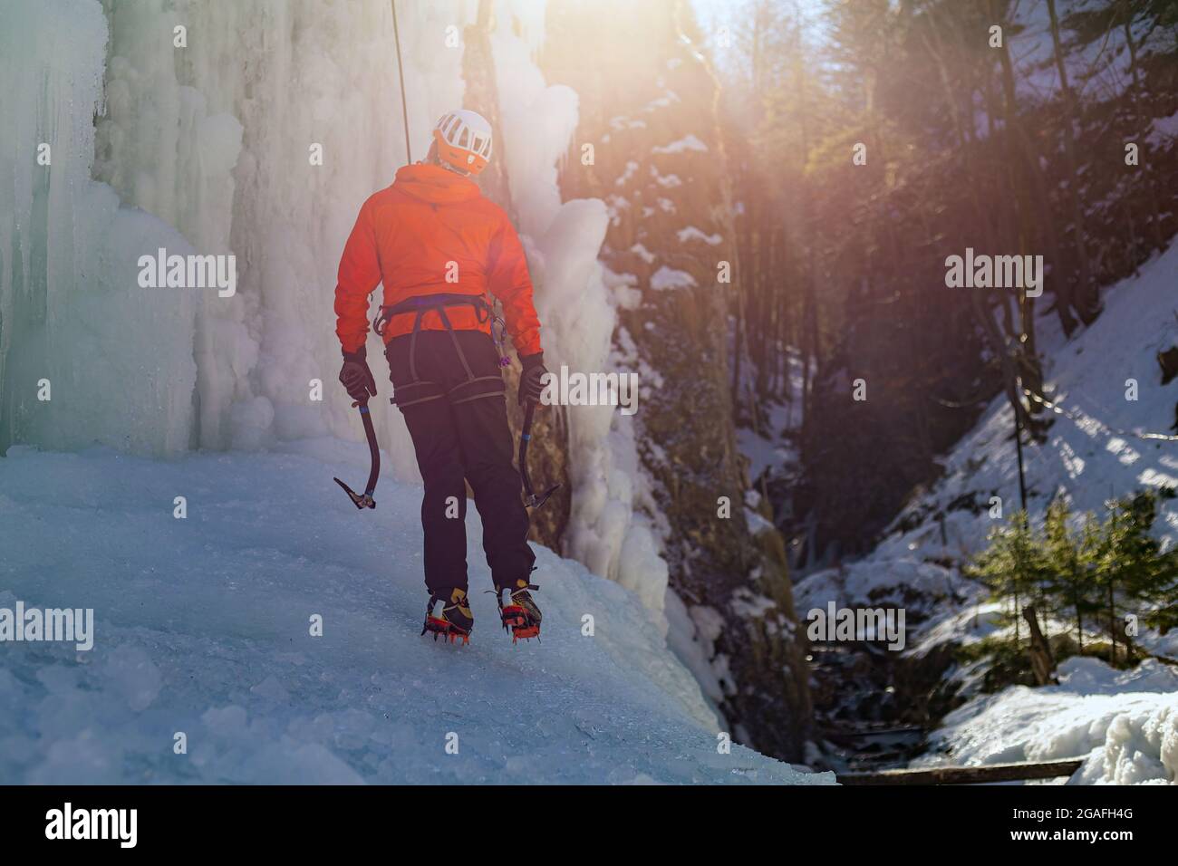 Male ice climber preparing for a climb Stock Photo - Alamy