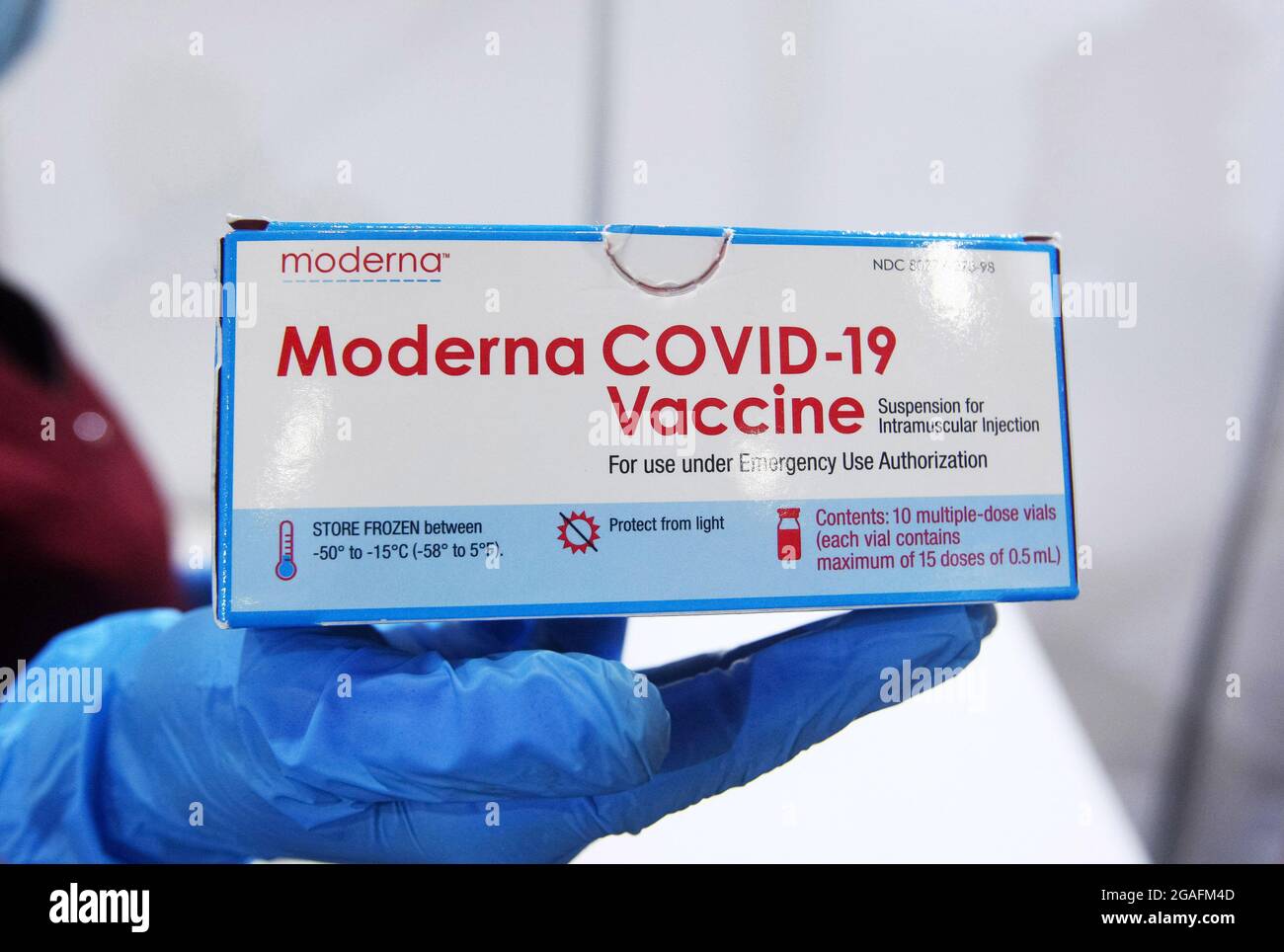 A medical worker holds a packaging of Moderna COVID-19 vaccine during ...