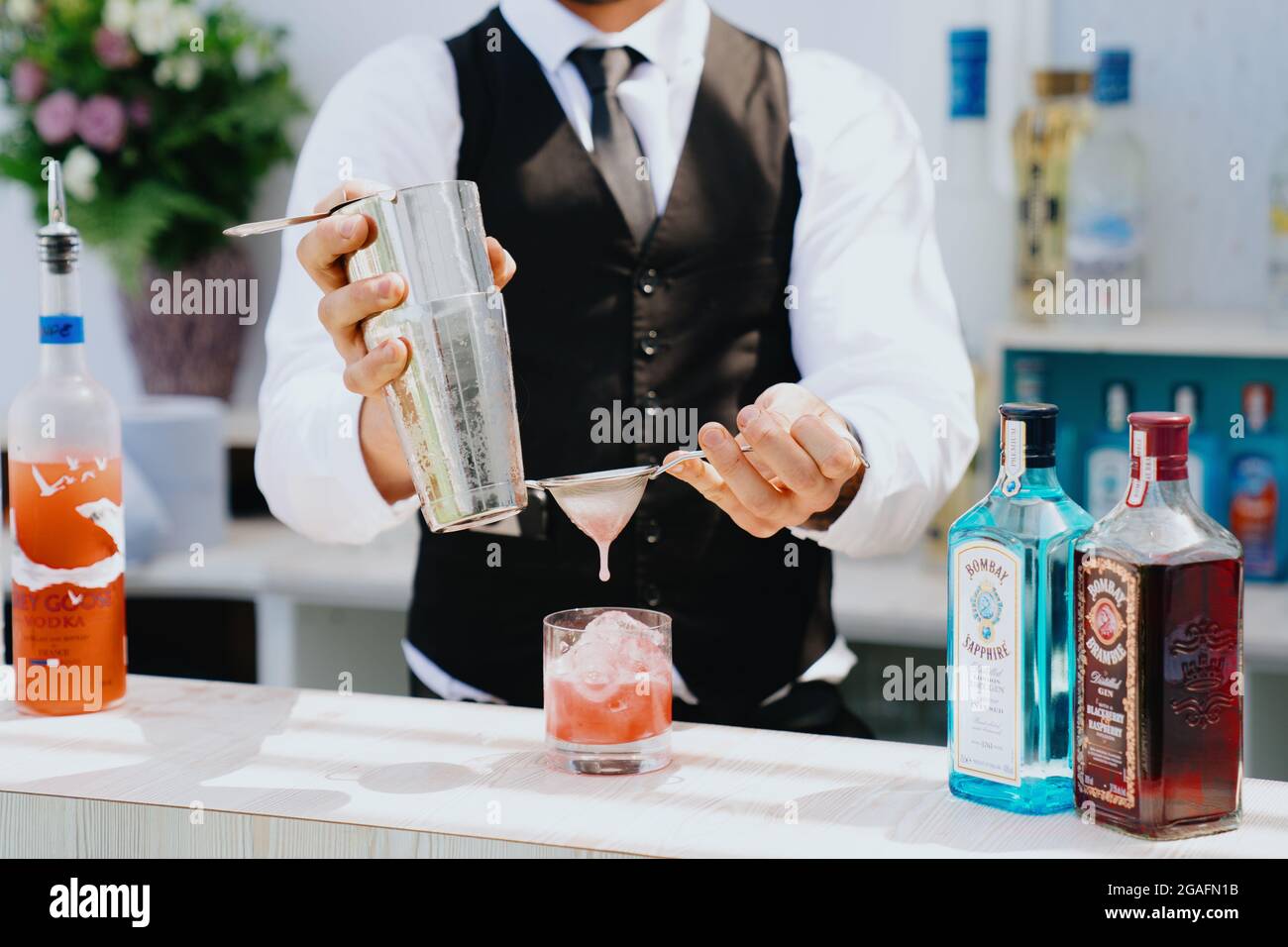 Bartender making a fruity cocktail Stock Photo - Alamy