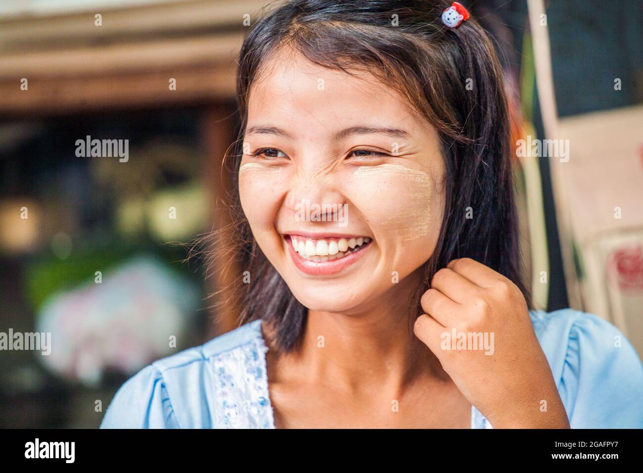 Very pretty Burmese girl with thanaka face powder on cheeks with pearly ...