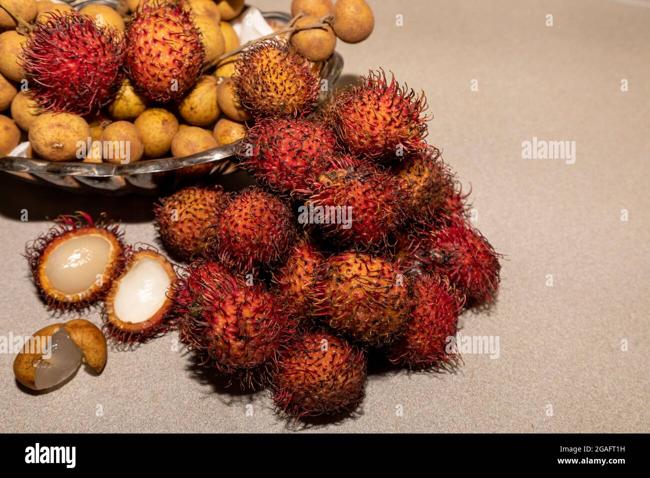 Exotic fruits Chom Chom (Rambutan) and Dimocarpus longan, commonly ...