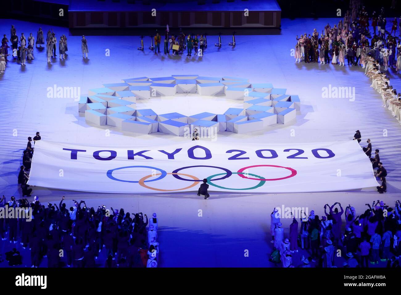 Tokyo, Japan, 23 July, 2021. Performers hold the Tokyo 2020 flag during ...
