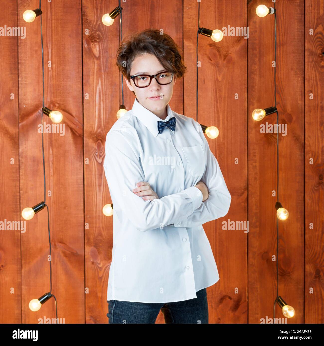 Smart teenager wearing glasses posing in loft apartment. Teenage girl ...