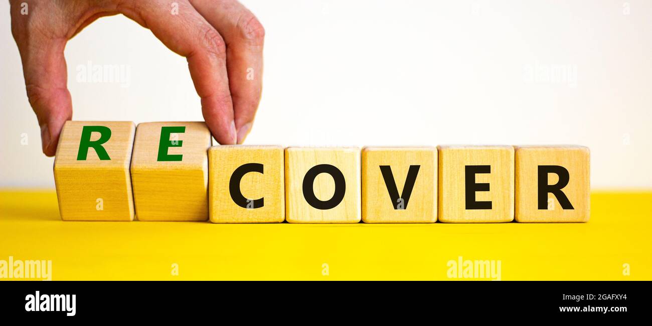 Time to recover symbol. Businessman turns wooden cubes and changes the ...