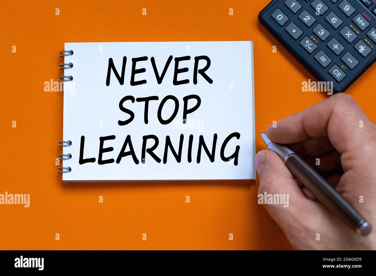 Never stop learning symbol. Businessman writing words Never stop ...