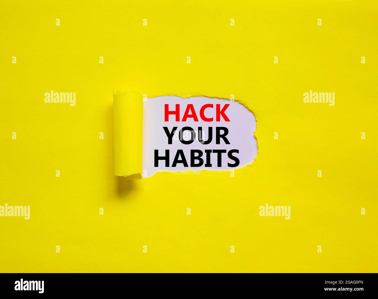 Hack your habits symbol. Words 'Hack your habits' appearing behind torn ...