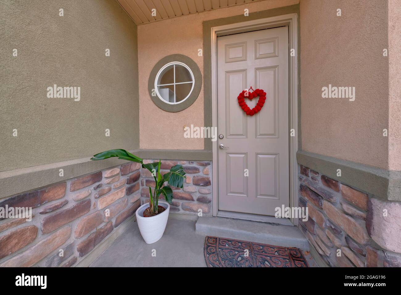 Front door exterior with red heart-shaped display at the front and a ...