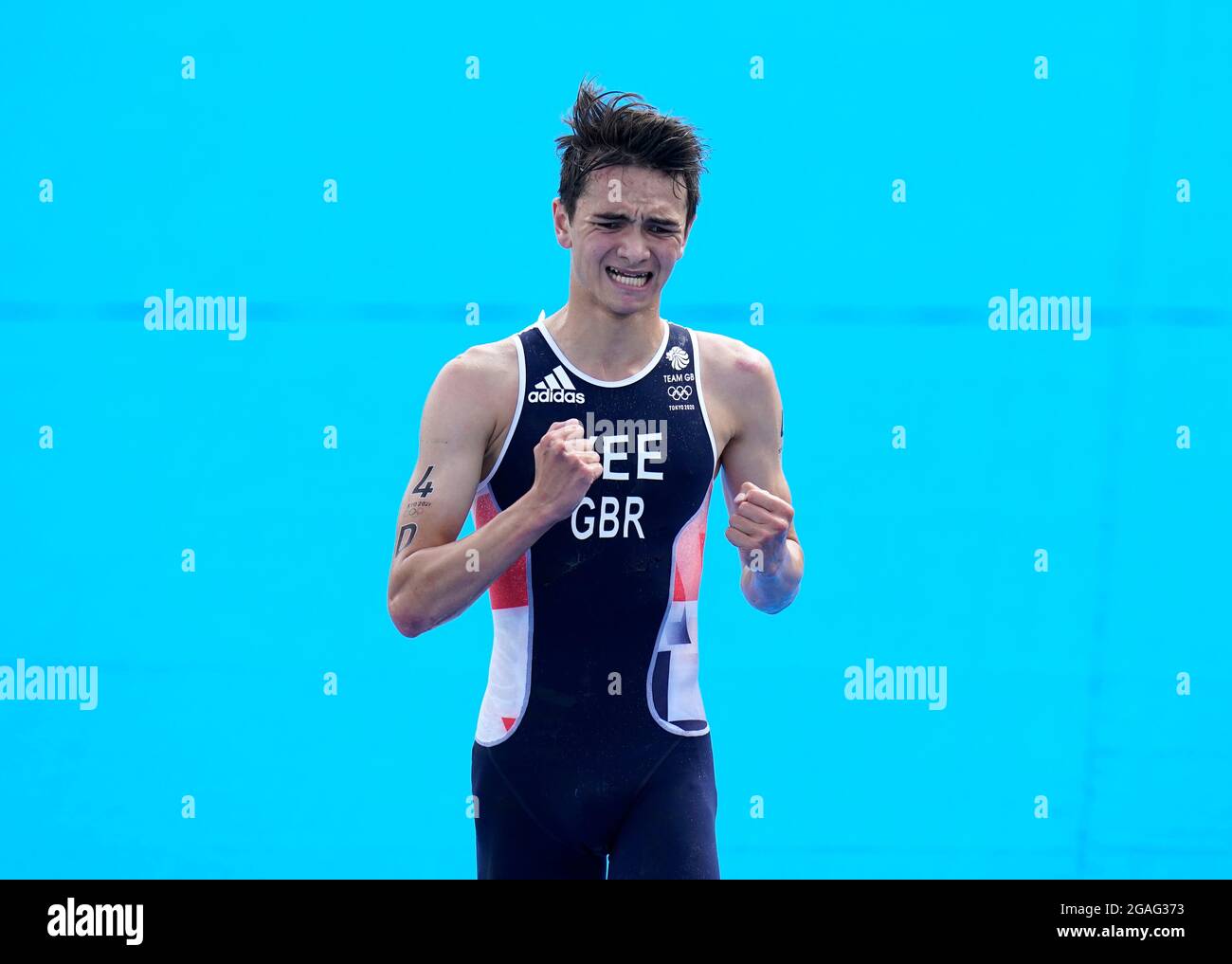 Great Britain's Alex Yee reacts as he crosses the finish line in the ...