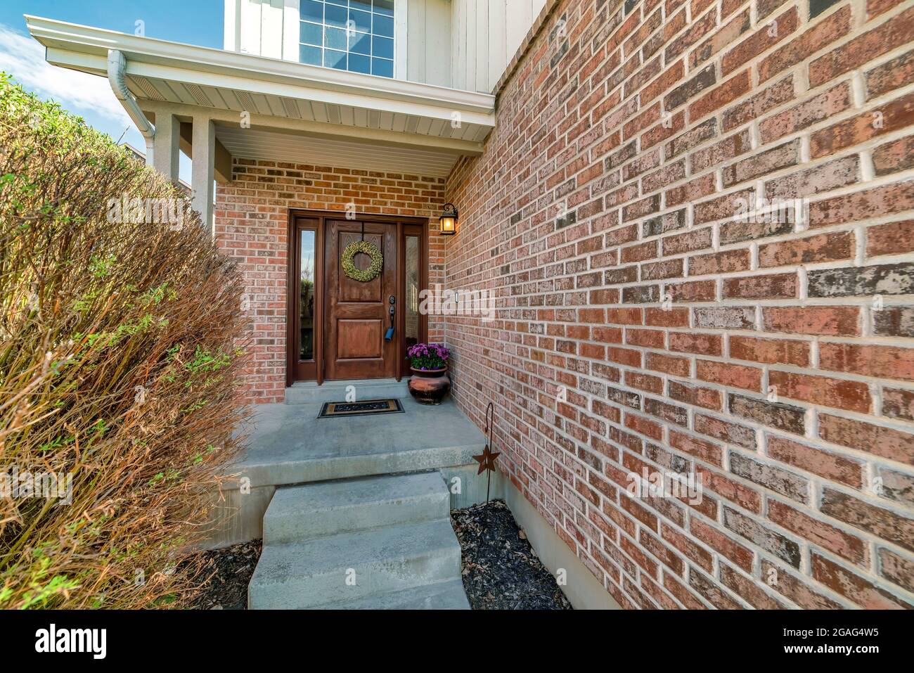 Entrance of a house with wooden front door and red bricks Stock Photo ...