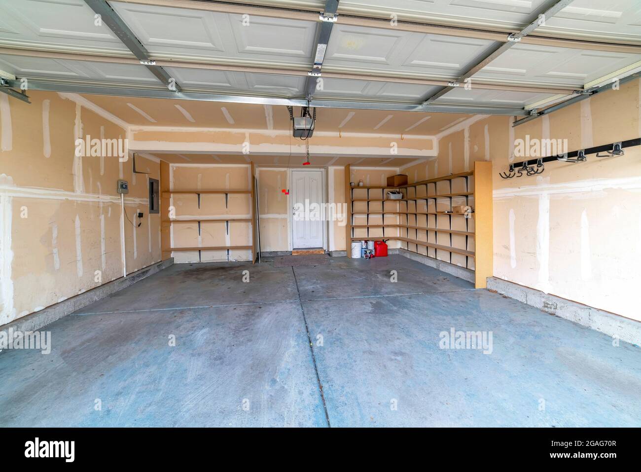 Interior of garage with a white line markings, wooden shelves and white ...