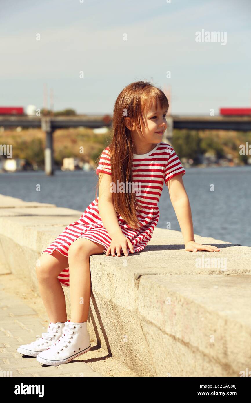 Little girl on the riverside Stock Photo - Alamy